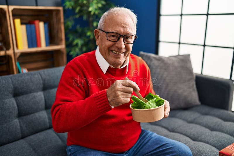Senior Man Eating Salad Sitting on Sofa at Home Stock Image - Image of ...