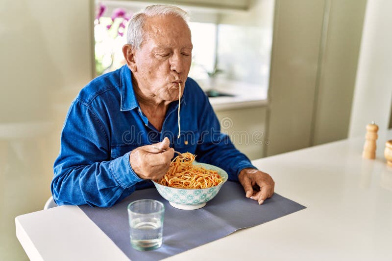 Senior Man Eating Spaghetti at Kitchen Stock Photo - Image of preparing ...