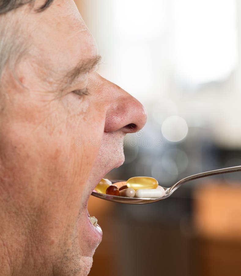 Senior Man Eating a Spoon of Vitamins Stock Photo - Image of adult ...