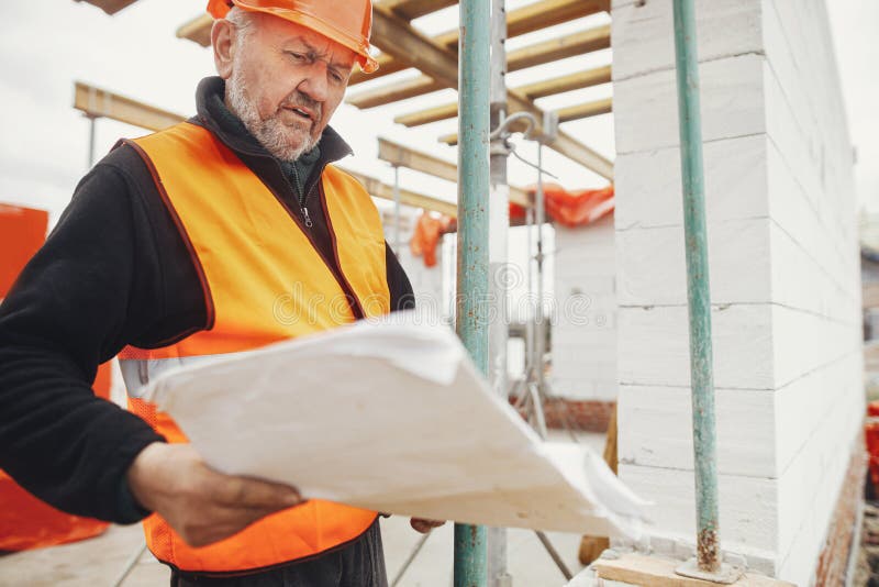 Senior Man Engineer or Construction Worker in Hardhat Looking at ... Senior Man Engineer or Construction Worker in Hardhat Looking at ...