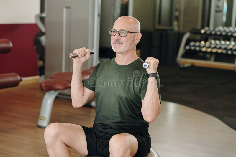 Senior Man Exercising with Dumbbells in Gym Stock Photo - Image of ...