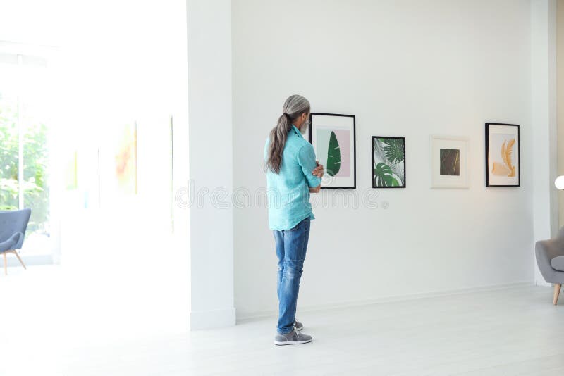 Senior man at exhibition stock photo. Image of person - 127252044