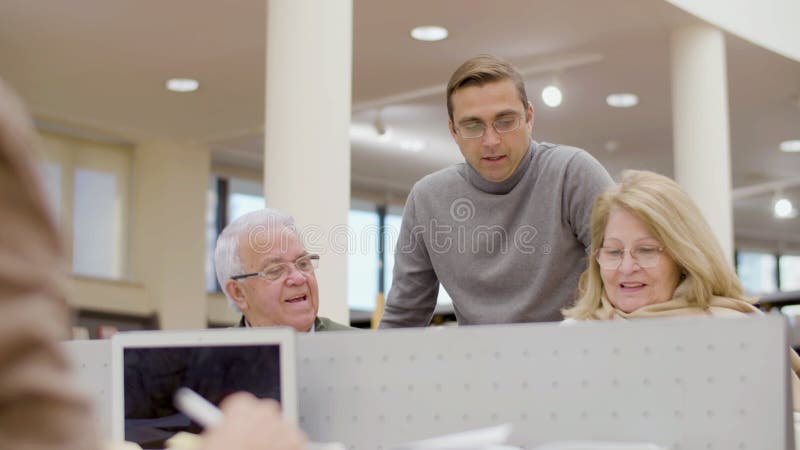 Senior Man Giving Textbook To Woman During Class In Library Stock Video Video Of Working
