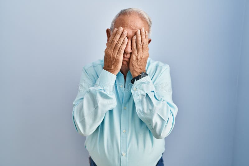 Senior Man with Grey Hair Standing Over Blue Background with Sad ...