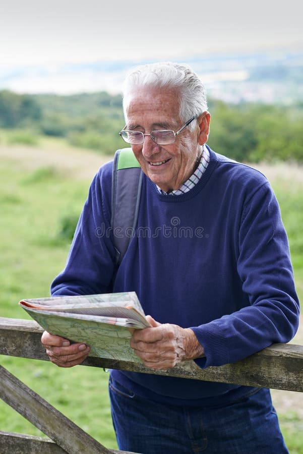 Senior Man Hiking in Countryside Looking at Map Stock Image - Image of ...
