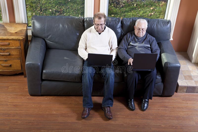 Volunteers Teaching a Senior How To Use a Computer Stock Photo - Image ...