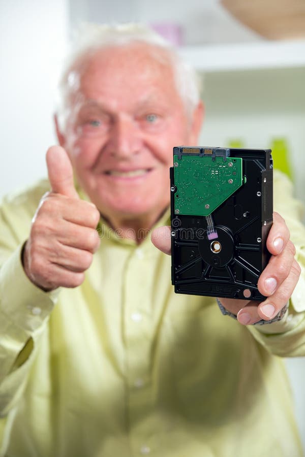 Senior Man Holding Hard Disk Stock Image - Image of astonished, golden ...