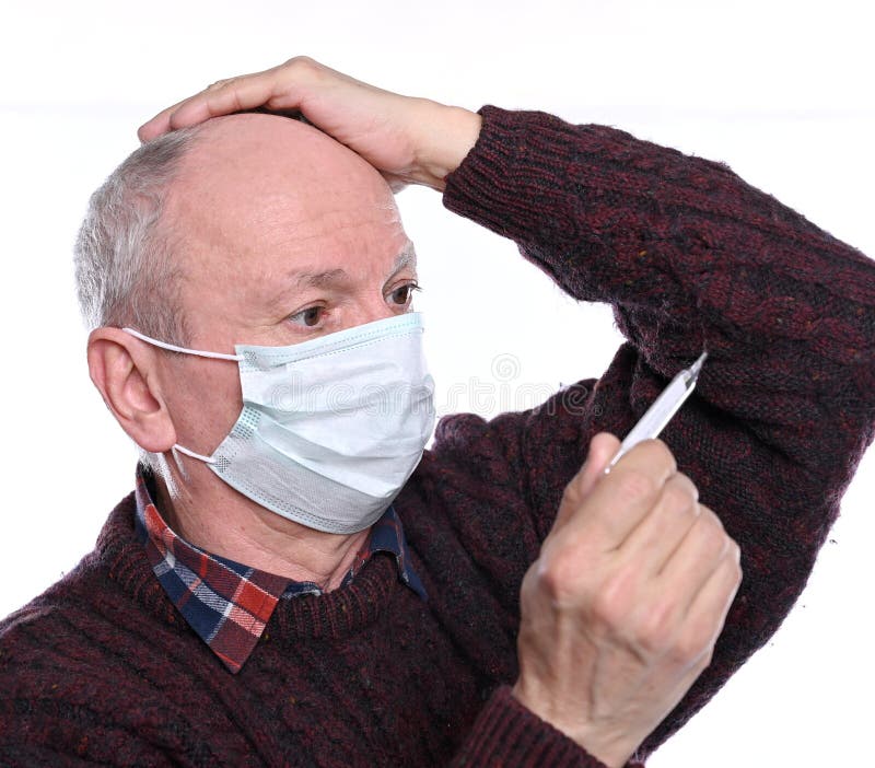 Senior Man Holding Thermometer In Hands Measuring Body Temperature