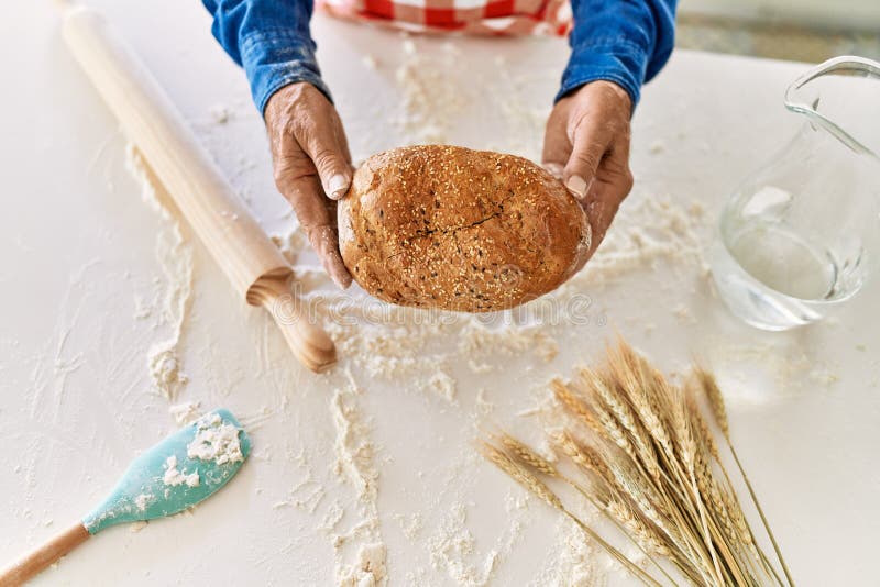 Senior Man Holding Wholemeal Bread at Kitchen Stock Photo - Image of ...