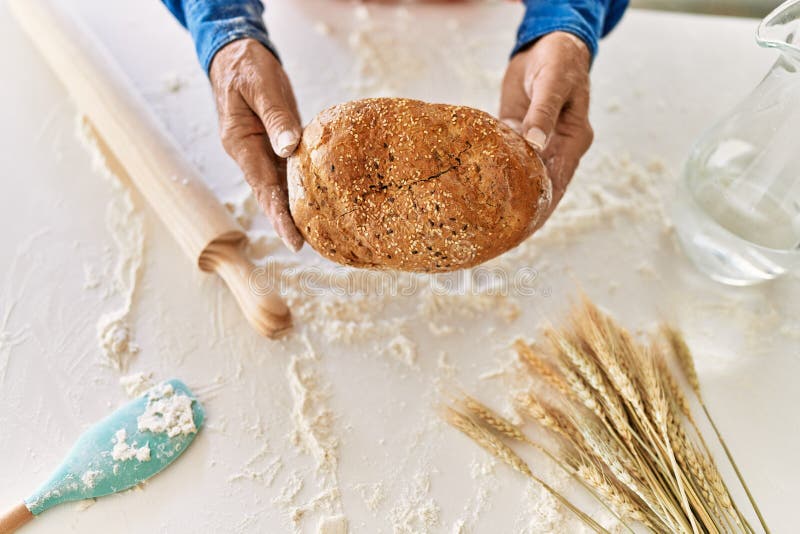 Senior Man Holding Wholemeal Bread at Kitchen Stock Photo - Image of ...