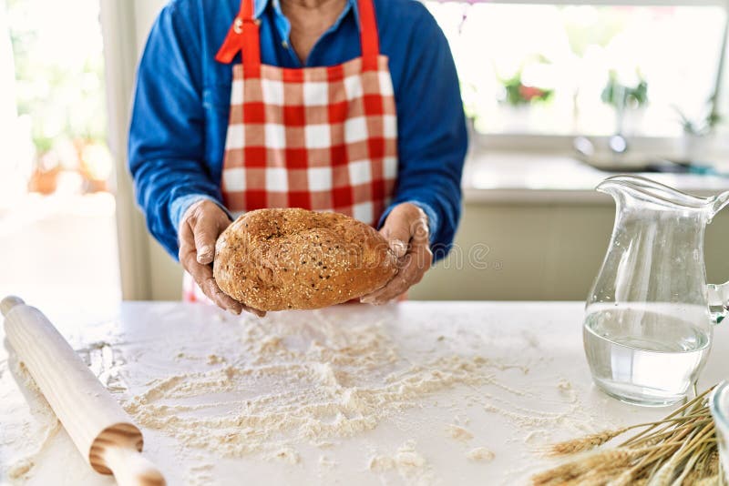 Senior Man Holding Wholemeal Bread at Kitchen Stock Photo - Image of ...