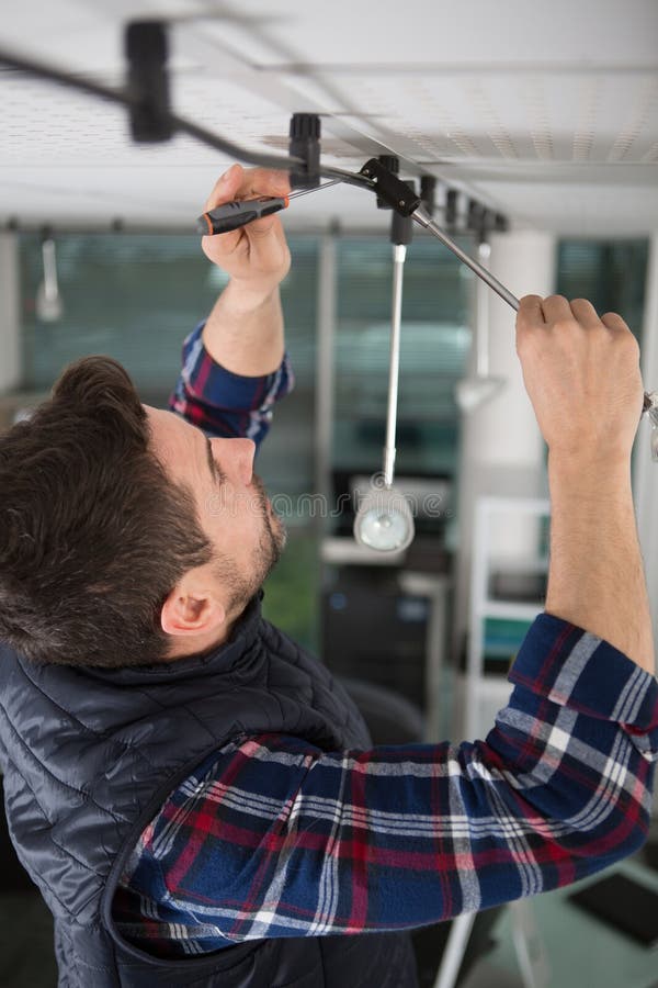 Senior Man Installing Ceiling Light Stock Image - Image of worker ...