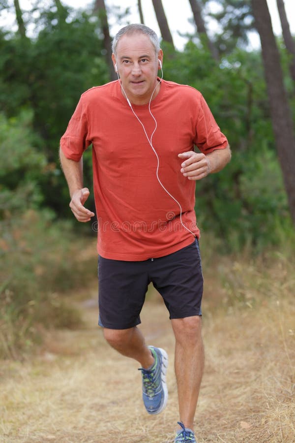 Senior Man Jogging Along Country Path Stock Photo - Image of oneperson ...