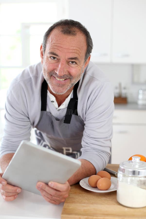 Senior Man in the Kitchen Searching for Recipe on Tablet Stock Image ...