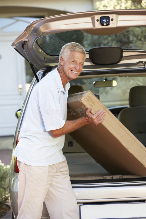 Senior Man Loading Large Package into Back of Car Stock Photo - Image ...