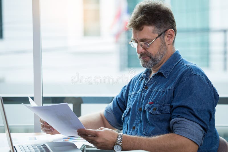 Senior Man Looking at Documents on the Desk. Stock Photo - Image of ...