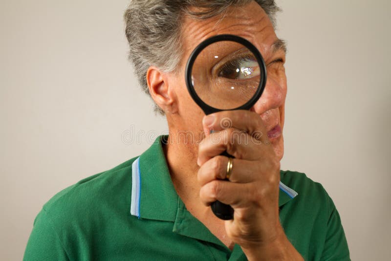 Man Looking through a Magnifying Glass Stock Image - Image of desk ...