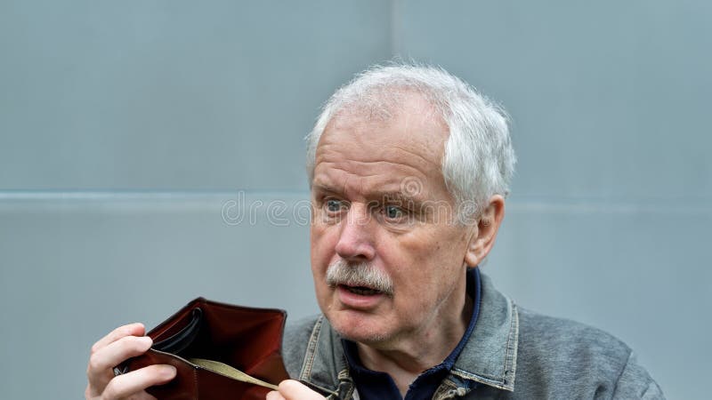 Senior Man Looking Shocked into Empty Wallet. Stock Photo - Image of ...