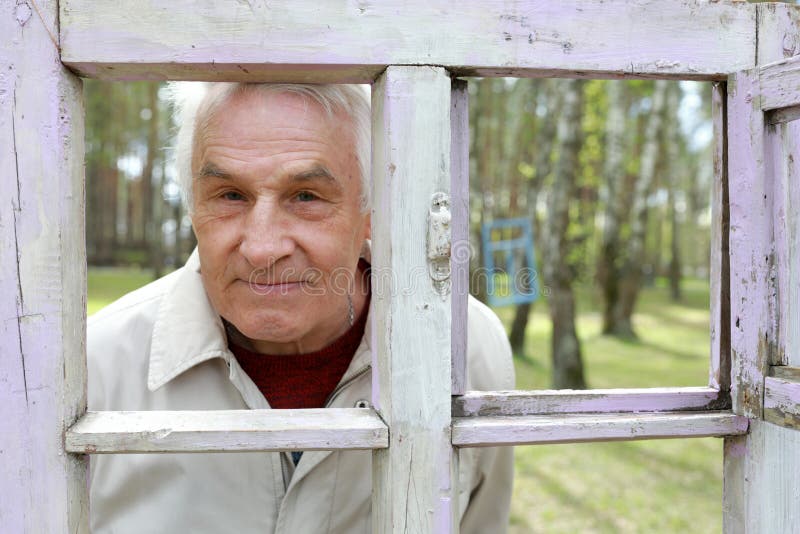Senior Man Looking through Wooden Frame Stock Image - Image of freedom ...