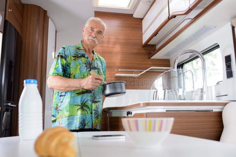 Senior Man Making Tea in Camper Van on Beach Stock Photo - Image of ...