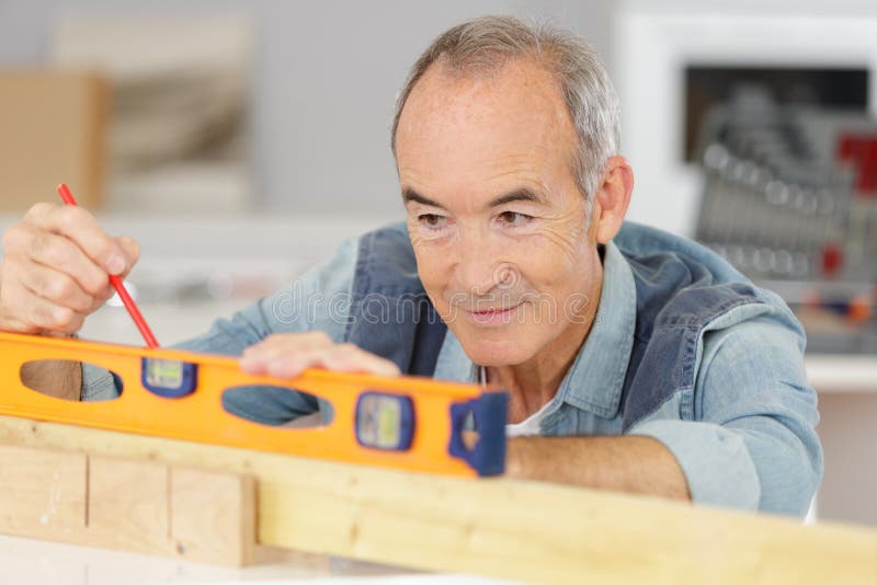 Senior Man Measuring Wall with Construction Level Stock Photo - Image ...