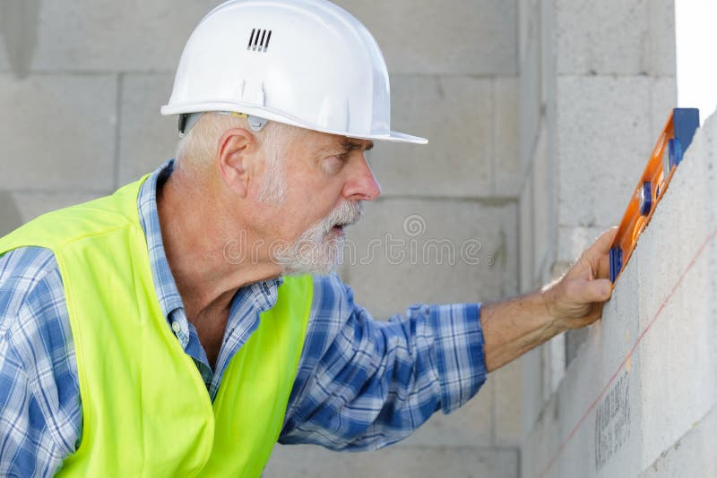 Senior Man Measuring Wall with Construction Level Stock Image - Image ...