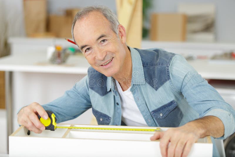 Senior man measuring wood stock image. Image of carpentry - 174509557