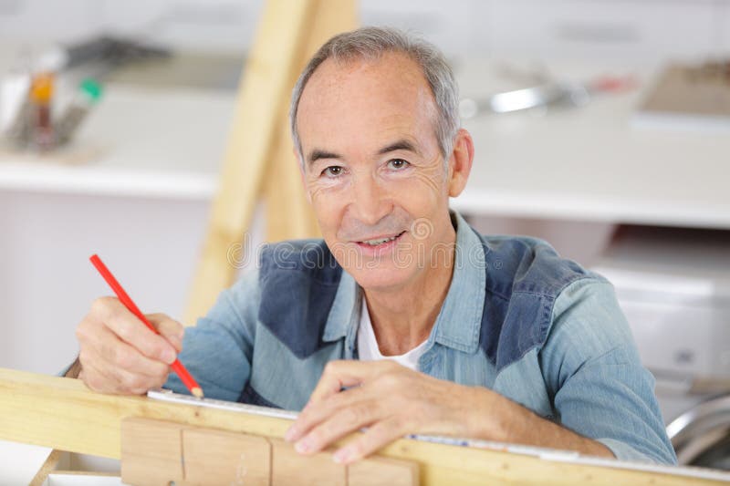 Senior Man Measuring Wood on Saw Stock Photo - Image of construction ...