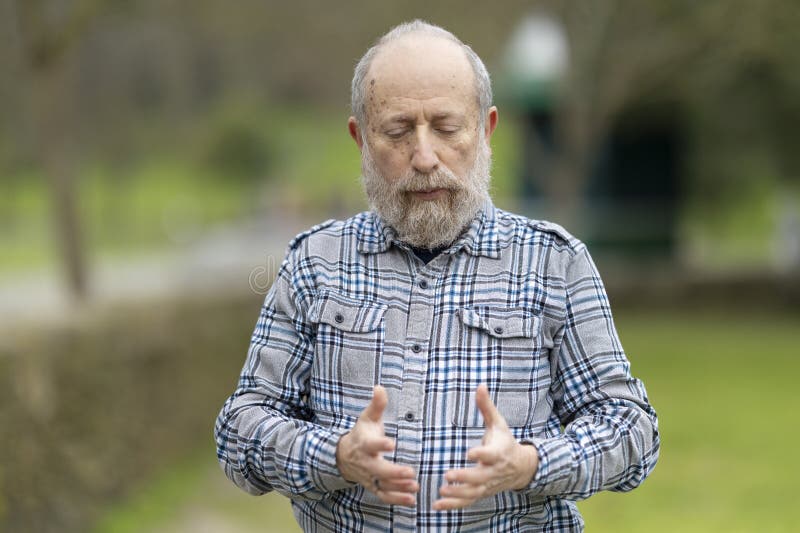 Senior Man Meditating in Public Park, Finding Inner Peace and ...