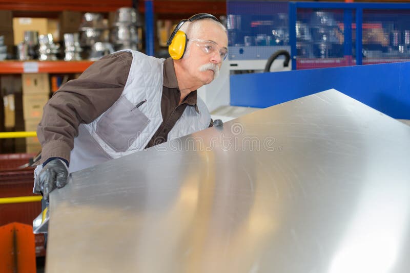 Senior Man Moving Sheet Metal Stock Image - Image of lifting ...