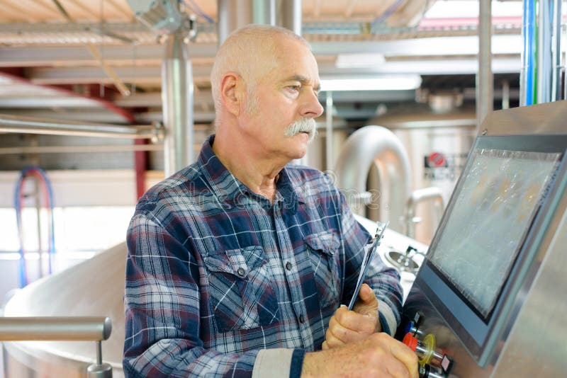 Senior Man Operating Machine in Industrial Plant Stock Image - Image of ...