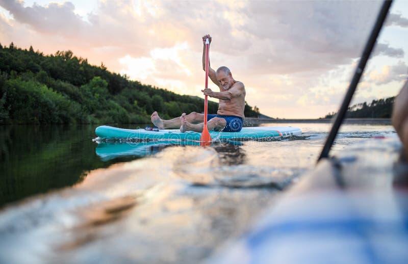 Senior Man Paddleboarding on Lake in Summer. Copy Space Stock Image ...