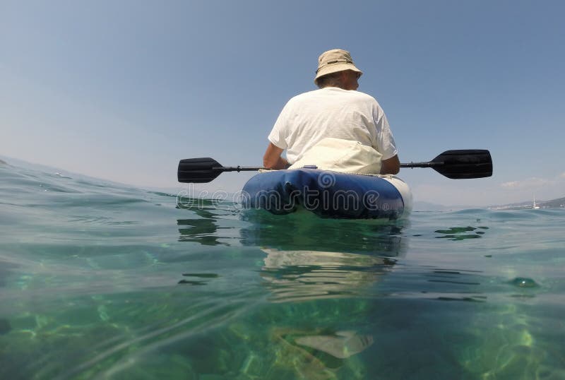 Senior Man Paddling in Kayak Stock Photo - Image of surface, trip ...