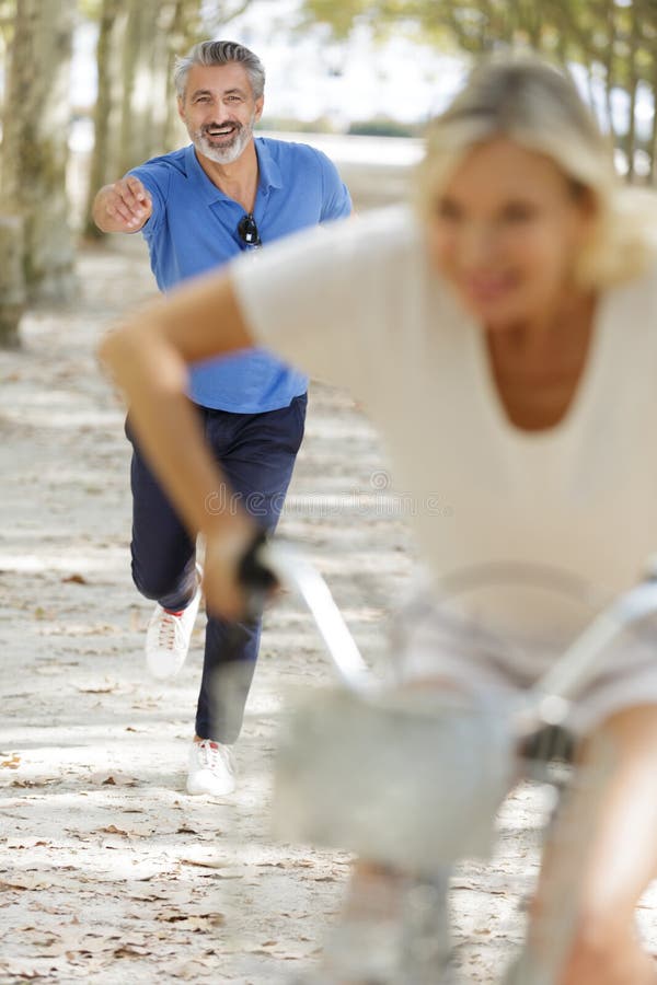 Man Chasing a Woman at the Beach Stock Image - Image of smiling ...