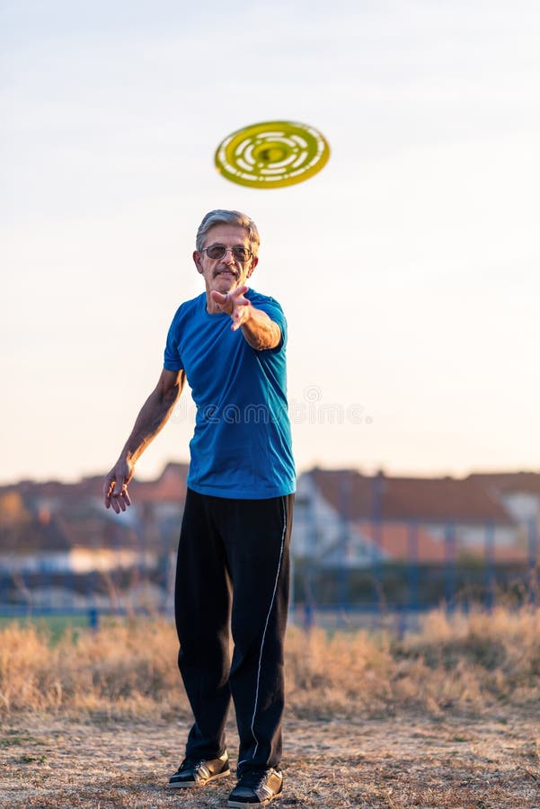 Senior Man Playing Frisbee in the Park Stock Image - Image of casual ...
