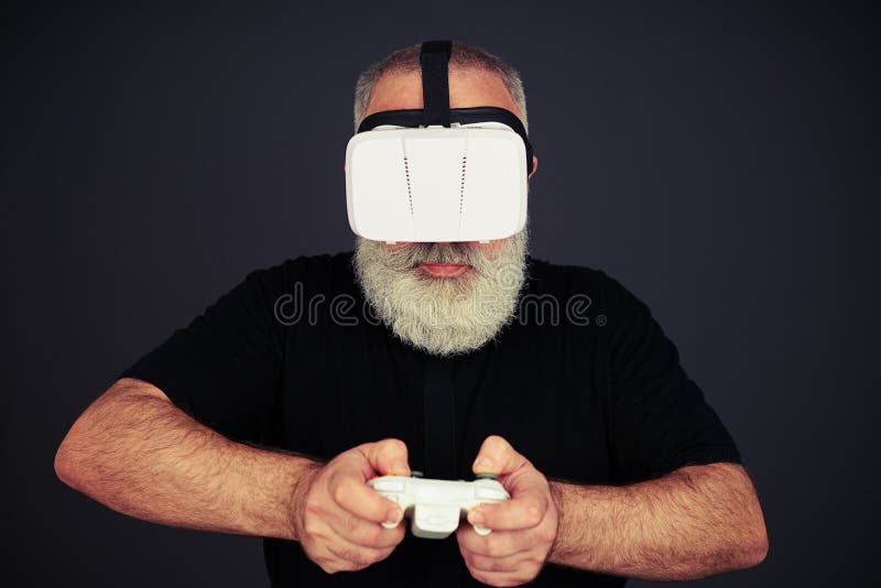 Senior Man is Playing on the Joystick Wearing Hi-tech VR Headset Stock ...