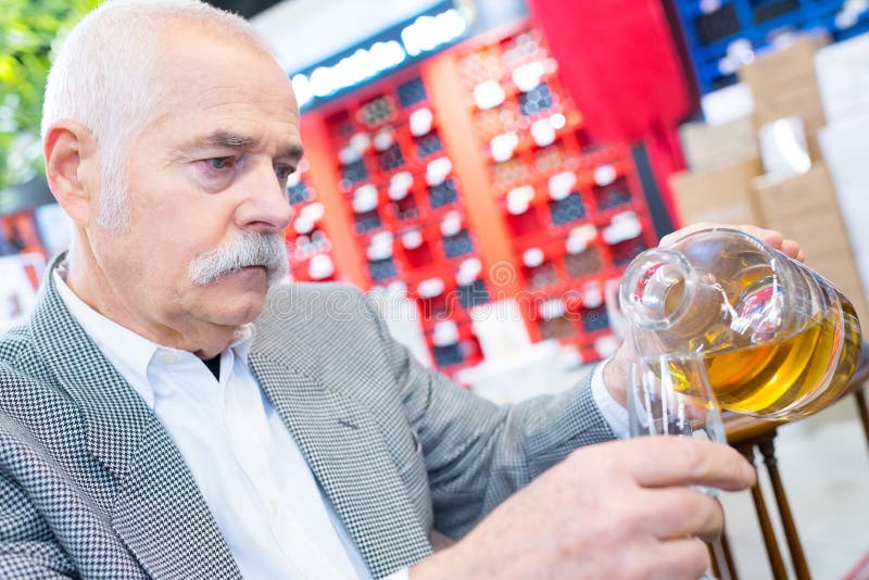 Senior Man Pouring Spirits into Glass Stock Image - Image of pour ...