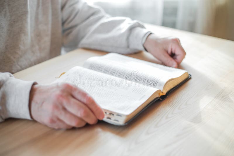 Senior Man Praying, Reading an Old Bible in His Hands Stock Photo ...