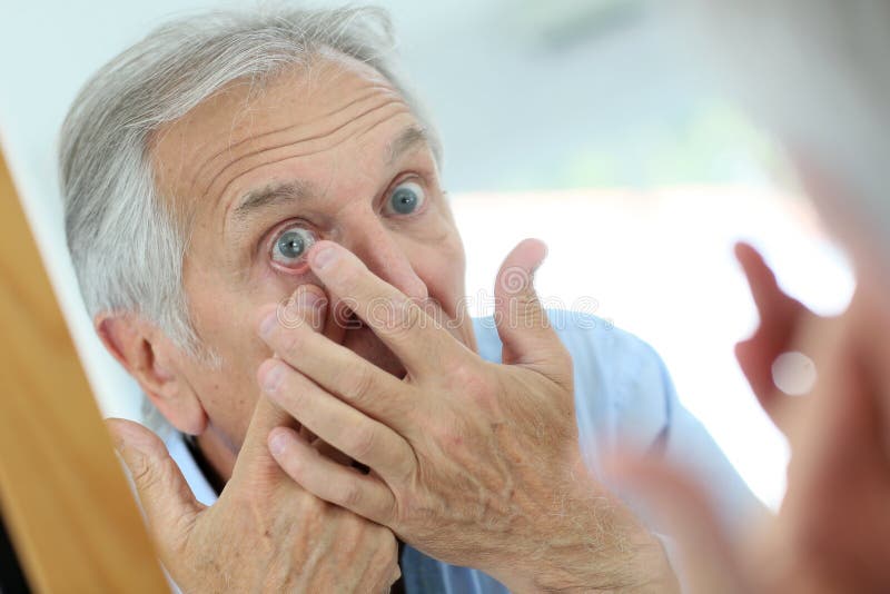 Senior Man Putting Contact Lens Stock Photo - Image of senior, eyecare ...
