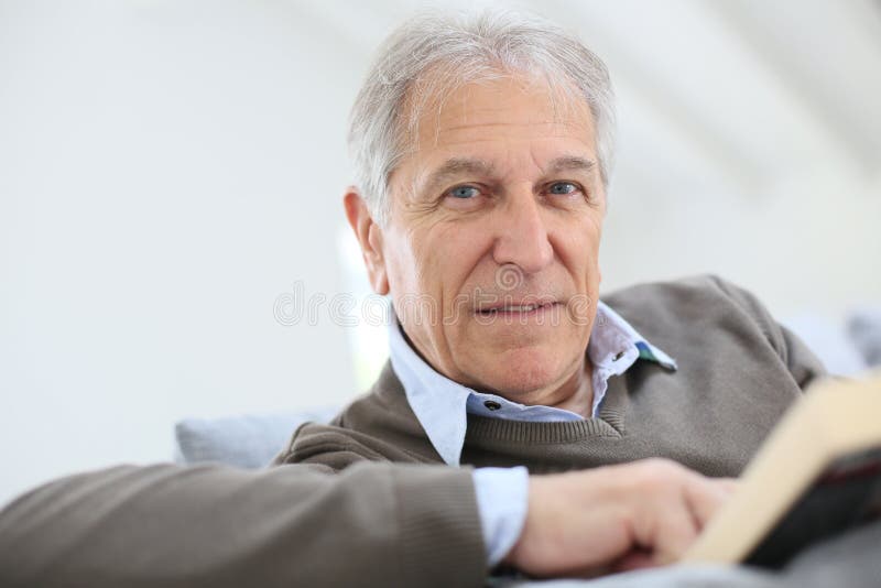 Senior man reading book stock photo. Image of relaxed - 64952480