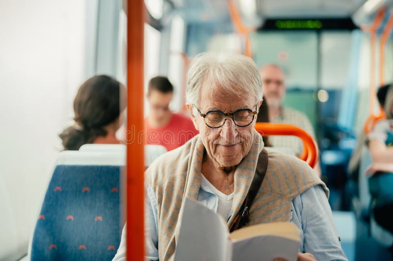 Senior Man Reading Book while Traveling with Bus Stock Photo - Image of ...