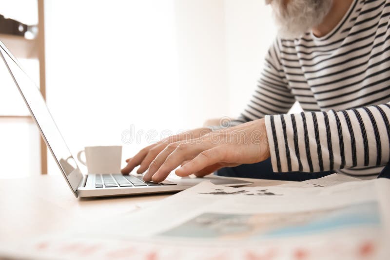 Senior Man Reading News on Laptop Screen at Home Stock Photo - Image of ...