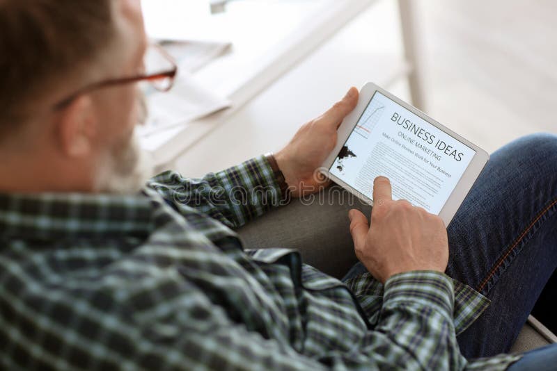 Senior Man Reading News on Tablet Screen at Home Stock Image - Image of ...
