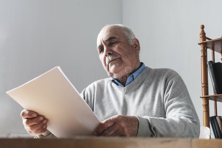 1,180 Thoughtful Man Reading Paper Stock Photos - Free & Royalty-Free ...