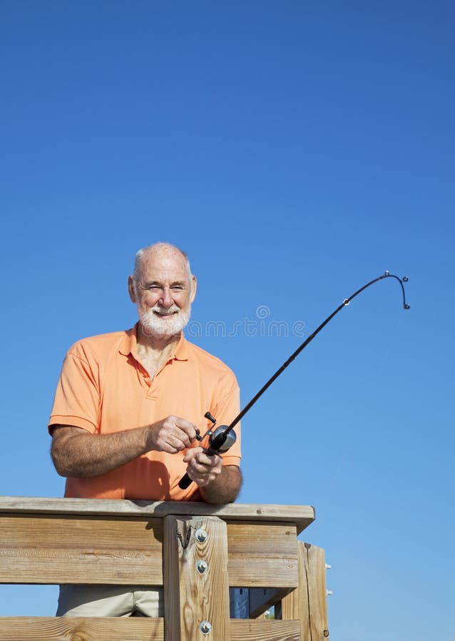 Senior Man Reels in Fish Vertical Stock Photo - Image of healthy, reel ...