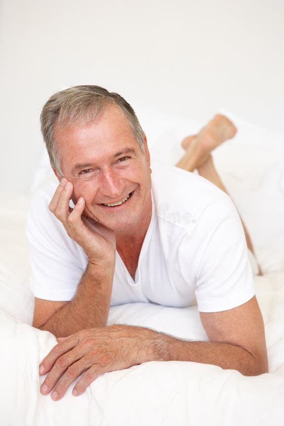 Senior Man Relaxing on Bed stock image. Image of retired - 14922043