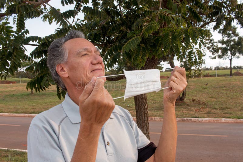 Senior Man Removing a Medical Mask from His Face; Panoramic Banner ...