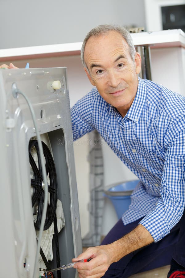 Senior Man Repairing Washing Machine Stock Photo - Image of caucasian ...