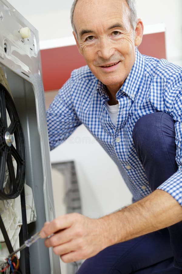 Senior Man Repairing Washing Machine Stock Photo - Image of male ...