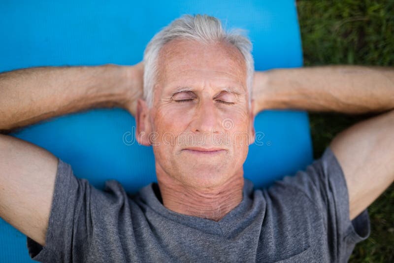 Senior Man Resting with Closed Eyes on Mat at Park Stock Photo - Image ...